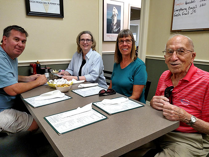 The true heart of any local cafe—regulars sharing stories and coffee, creating the community soundtrack that no corporate chain can replicate.