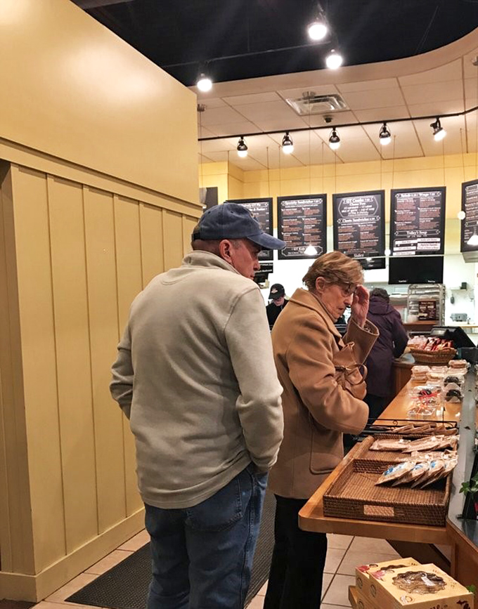 Decision paralysis is real when faced with a display case of freshly baked goods—these customers know the struggle is deliciously real.