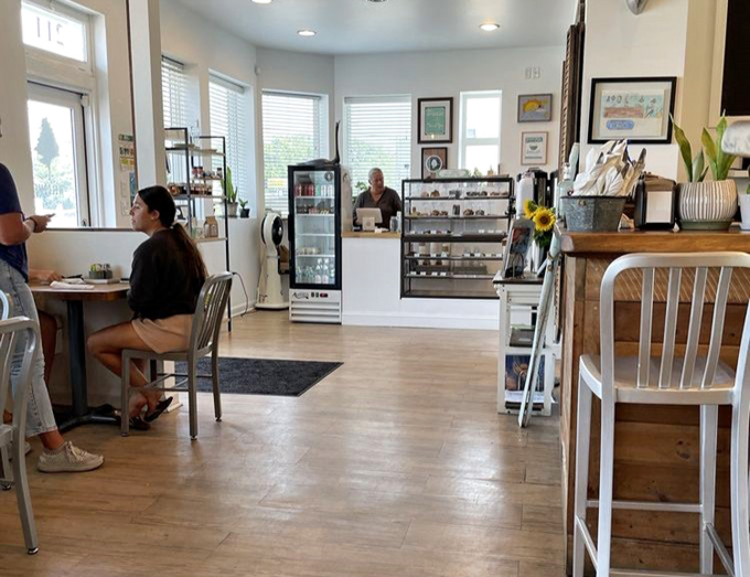 The bright, welcoming dining area invites lingering conversations over coffee refills. Notice the pastry case tempting you from afar.