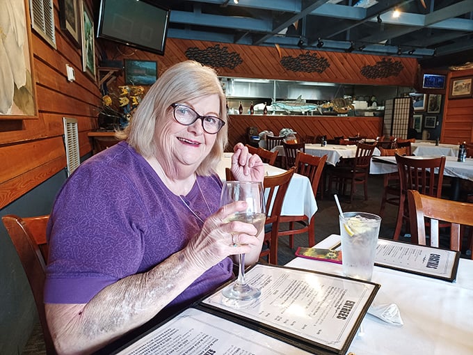 The joy of discovering exceptional seafood is written all over this diner's face. That glass probably contains something celebratory.