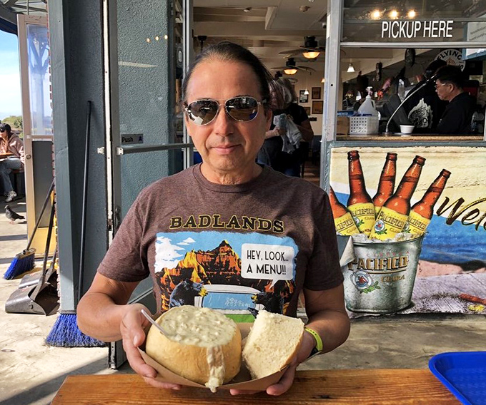 That bread bowl of chowder isn't just being held&mdash;it's being treasured. The look says it all: "This is why I drove up the coast today."