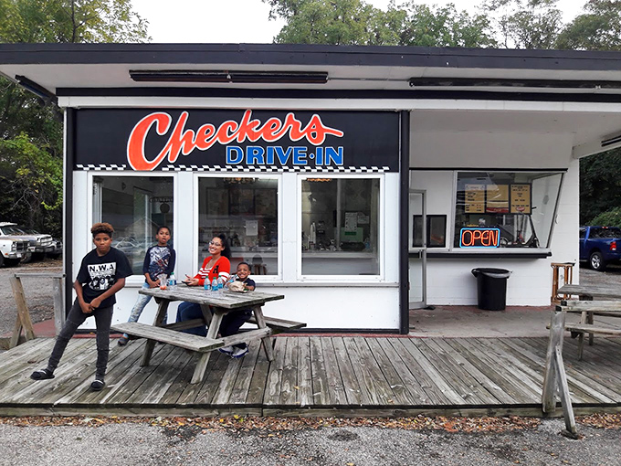 The wooden deck becomes an impromptu community center where strangers become friends over shared appreciation for simple, honest food.