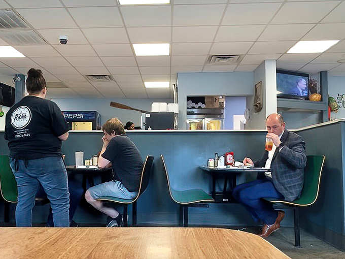 The true measure of a local institution: businessmen in suits sharing space with families and solo diners, all united by the universal language of good food.
