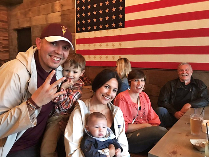 Nothing says "this place is legit" like families gathering under an American flag. Three generations bonding over brisket is the new American dream.