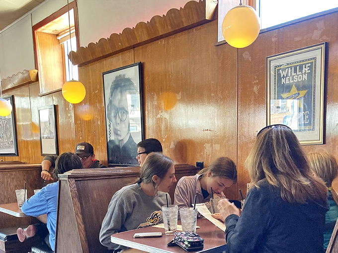The wood-paneled walls adorned with music memorabilia create the perfect backdrop for hot dog enthusiasts plotting their next topping combinations.
