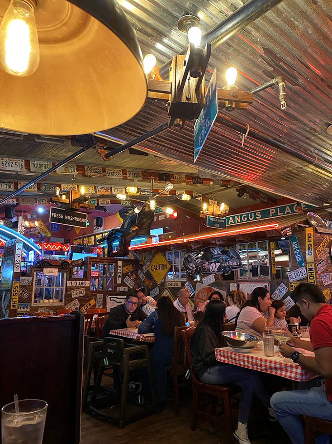 Happy diners surrounded by license plates and street signs create the perfect dining atmosphere.