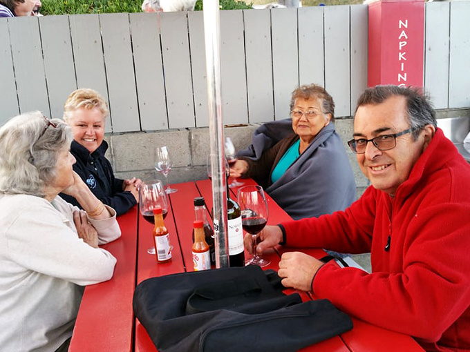 Wine bottles and laughter flow freely at these picnic tables, where strangers become friends united by the universal language of great seafood.
