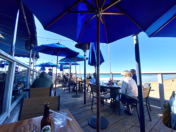 The outdoor patio at Fisherman's offers the kind of million-dollar view that real estate agents dream about, with blue umbrellas matching the endless ocean horizon.