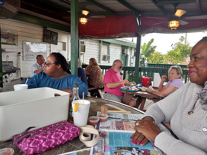 The screened porch dining area: where strangers become friends over the universal language of "Can you pass the crab mallet?" and "Is that butter on your chin?"