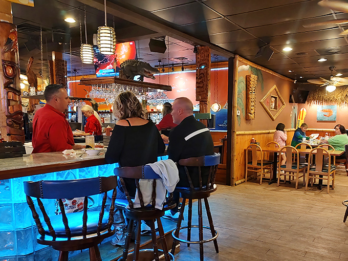 The bar area&mdash;where locals swap fishing tales and tourists pretend they know what they're talking about. The blue lighting adds underwater ambiance.