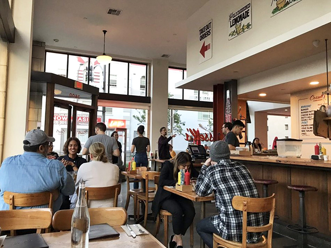 A bustling dining room where strangers become temporary neighbors united by one thing: the pursuit of burger perfection.