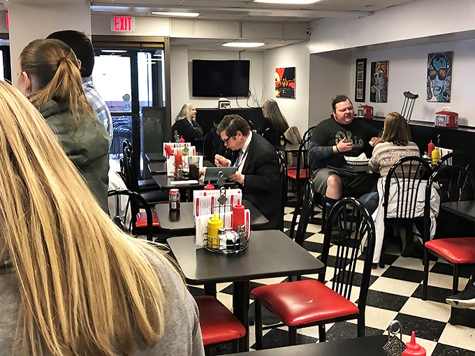 A dining room where suits and t-shirts coexist peacefully, united by the universal language of good food.