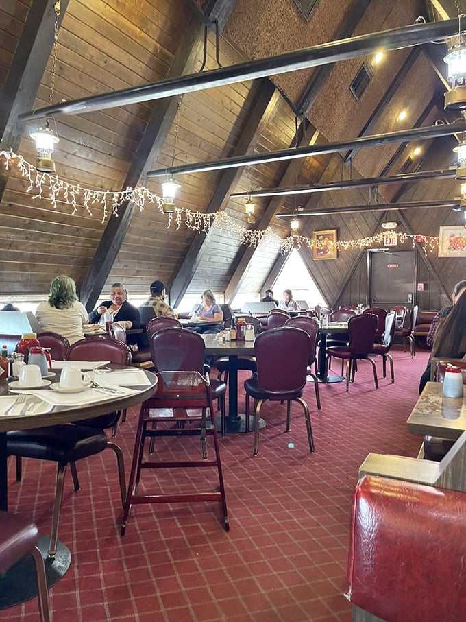 The dining room buzzes with conversation under dramatic wooden beams. Notice the string lights&mdash;they're not just for Christmas, they're for ambiance year-round.