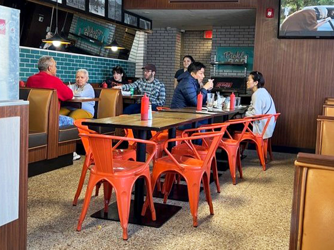 Those orange metal chairs aren't just stylish&mdash;they're front-row seats to the delicious drama unfolding in this retro culinary theater.