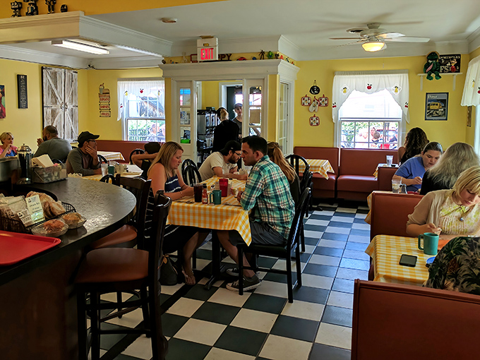 The black and white checkered floor and bustling tables create that perfect diner symphony&mdash;equal parts conversation buzz and silverware percussion.