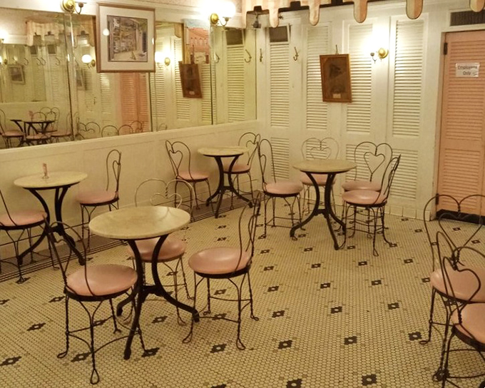 Pink chairs and marble tables waiting for the next ice cream pilgrims. Time stands still in this corner of dessert paradise.