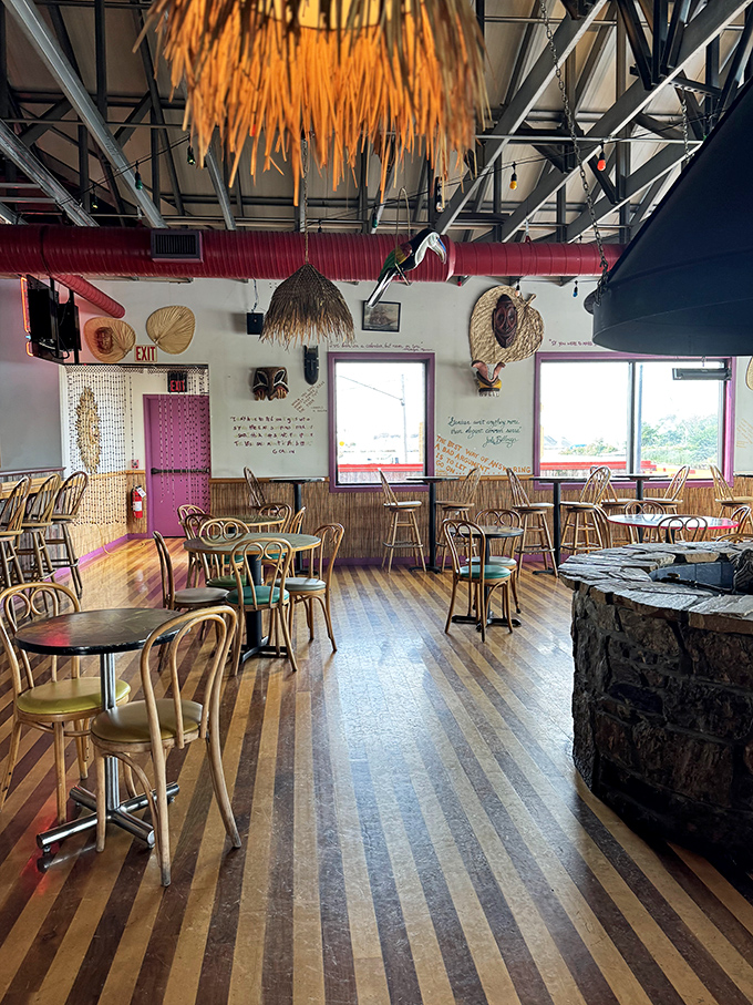 Striped floors, thatched umbrellas, and bamboo details—this dining room feels like a Jimmy Buffett song came to life in Ohio.
