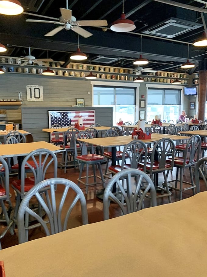 The dining room hums with anticipation of seafood feasts to come. Red chairs and wooden tables set the stage for memorable Maryland meals.
