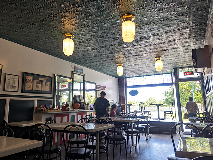 Vintage pendant lights cast a warm glow over simple tables where countless food memories have been made since long before Instagram existed.
