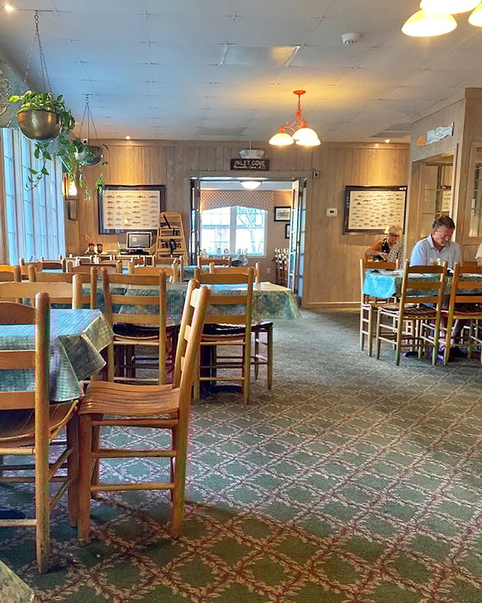 Inside Lee's, wooden chairs have supported generations of happy diners. The carpet pattern? Pure nostalgic charm that screams "the food matters more."