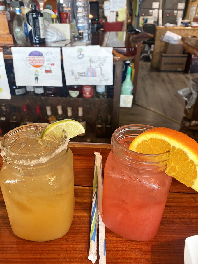 Mason jar cocktails that say "vacation" even if you're just on lunch break. That citrus garnish isn't just pretty&mdash;it's doing important work.