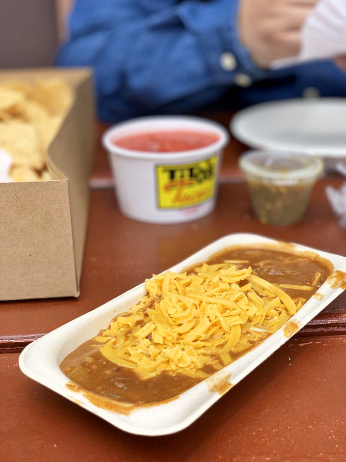 Bean-laden bliss in a tray. The enchilada's saucy embrace is like a warm hug from your favorite aunt who always feeds you too much.