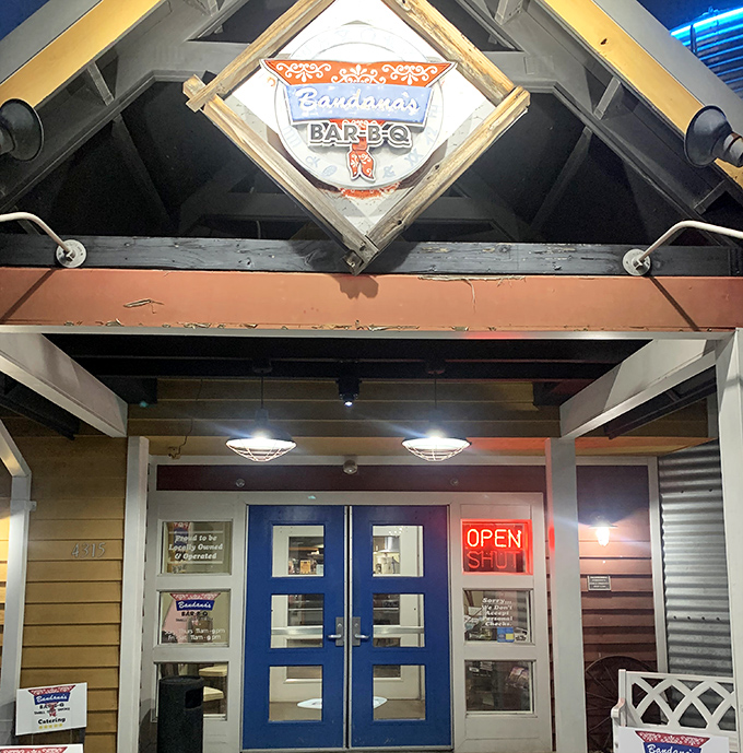 The blue doors beneath the diamond-shaped logo create an entrance that's both welcoming and Instagram-worthy, especially when that neon "OPEN" sign is glowing.
