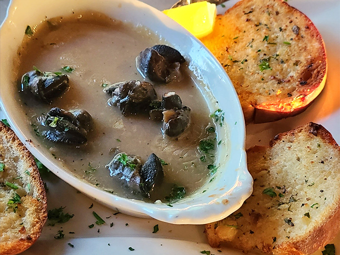 Escargot swimming in garlicky goodness with toasted bread standing by for the essential sauce-sopping mission. Napkins, prepare for duty! 