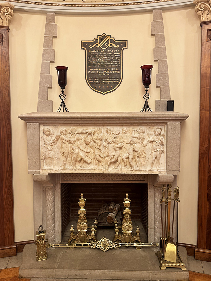 This isn't just a fireplace&mdash;it's a stone canvas telling stories through intricate carvings, topped with a plaque that reminds us we're standing in history.