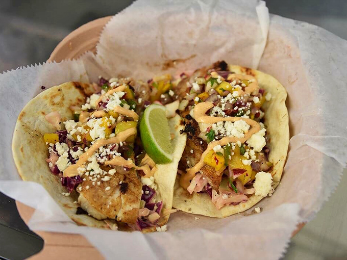 Seafood tacos with enough crumbled cheese to make you temporarily forget about whatever diet you were considering. Worth every napkin you'll need.