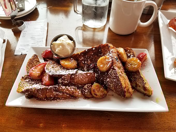 French toast that's had a spa day&mdash;pampered with caramelized fruits, powdered sugar, and what appears to be the world's most photogenic whipped cream.