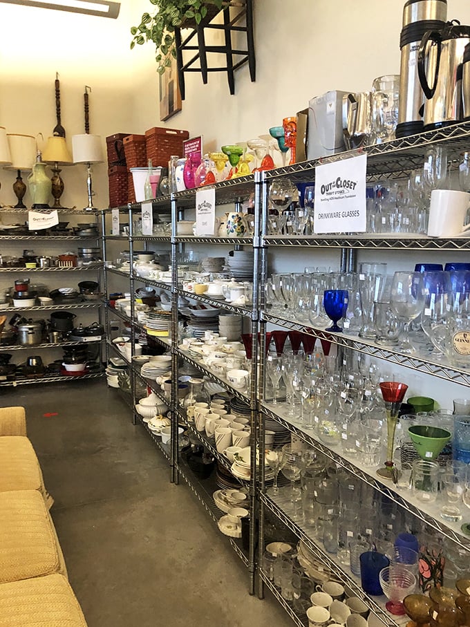 Crystal, everyday glassware, and dishware line industrial shelving in neat rows. Someone's wedding registry rejects become another's entertaining essentials at a fraction of department store prices.