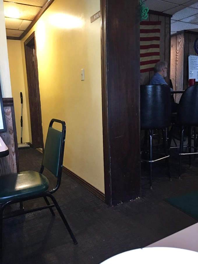 The hallway at Tim's reveals its unpretentious charm &ndash; simple furnishings and an American flag that remind you this is authentic small-town dining at its finest.