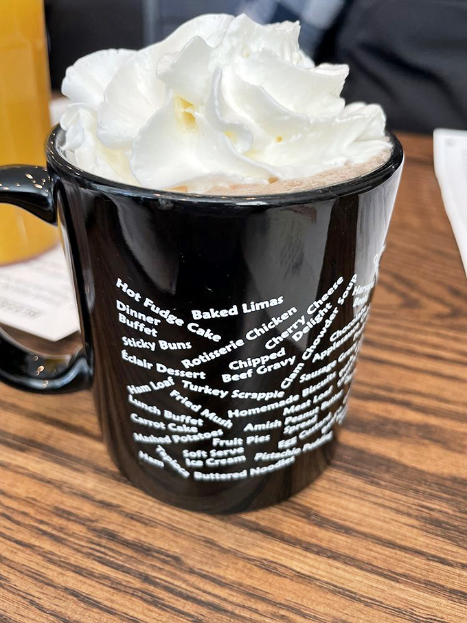 Hot chocolate crowned with a cloud of whipped cream, served in a mug that catalogs the restaurant's greatest hits. Liquid dessert that warms from the inside out.
