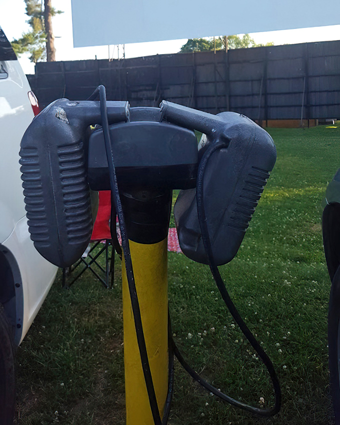 A nostalgic relic meets modern convenience. These speaker posts now serve as radio frequency reminders, connecting cars to the soundtrack of summer nights.