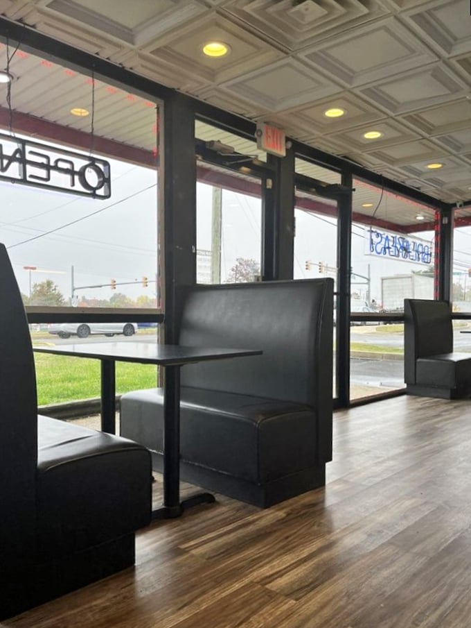 Simple black booths against wooden floors create the perfect stage where the real star&mdash;that legendary fried chicken&mdash;can shine without distraction.