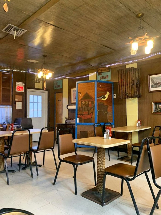 Blue string lights add a touch of whimsy to the nautical-themed dining room. Those rope-based table stands? Pure maritime charm.