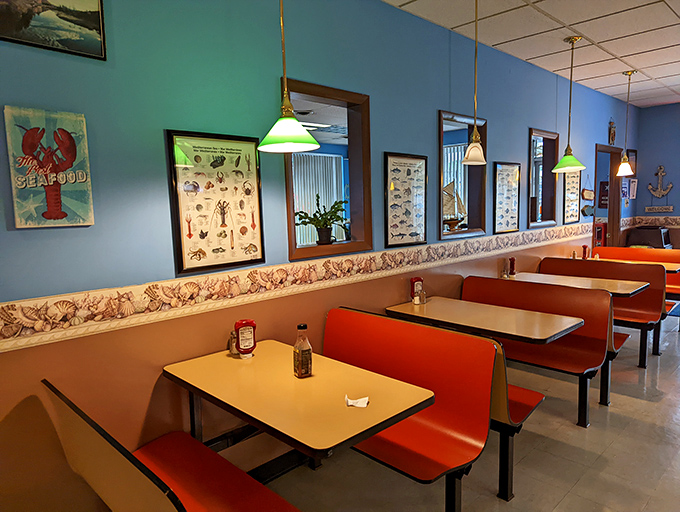 Classic diner-style booths under pendant lights create that "come as you are" vibe. The seafood charts on the wall remind you this isn't your average diner.