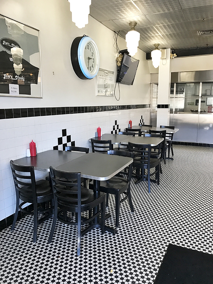 Classic diner seating with the timeless black and white aesthetic. Where cheesesteak memories are made, one table at a time.