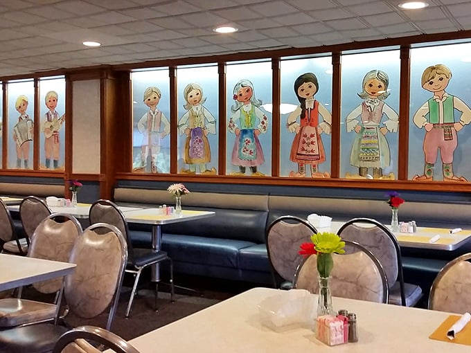 The dining room's folk art windows tell stories of heritage while booths stand ready for the creation of new family memories.