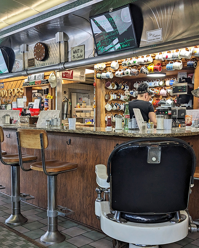 Coffee mugs hanging like trophies and a classic barber chair&mdash;this isn't just a diner, it's a museum of American comfort.