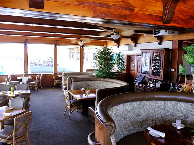 Curved booths and tropical plants create dining nooks that feel both intimate and airy&mdash;like your wealthy friend's beach house you wish they'd invite you to more often.