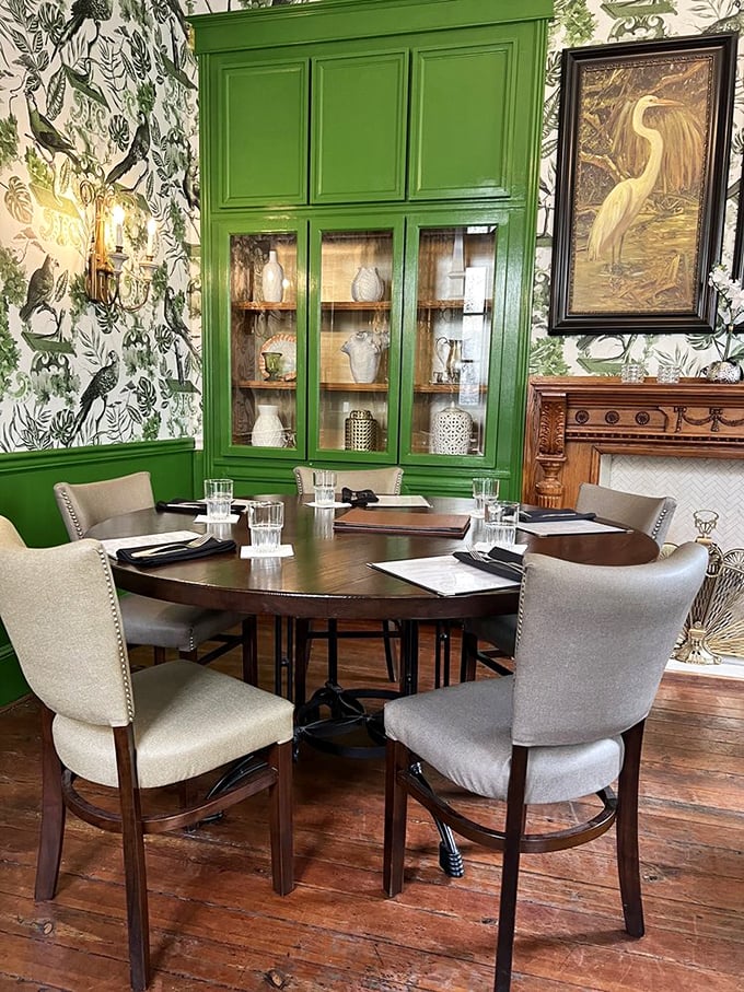 The emerald dining room houses vintage display cabinets and period-perfect furnishings. It's like eating inside a Southern design magazine spread. 