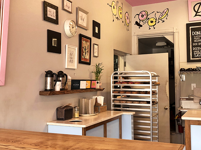 Warm wooden accents and playful wall art create the perfect backdrop for the serious business of donut consumption.