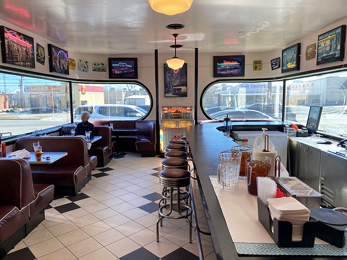 The counter seating area offers front-row views of short-order magic, where regulars exchange friendly banter beneath vintage-inspired lighting.