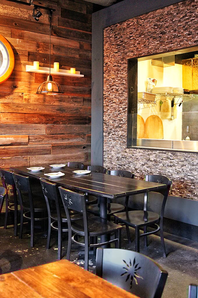 The marriage of rustic wood and textured stone creates a dining space that feels both modern and timeless&mdash;like dining in a very stylish cave.