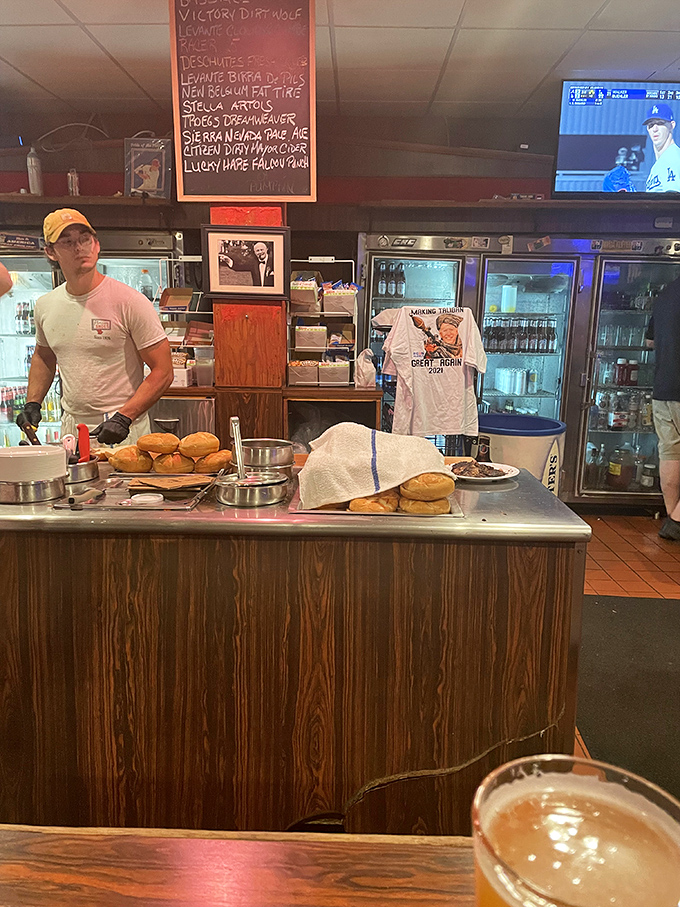 Behind the counter, where sandwich magic happens. The beer list on the board promises liquid happiness to accompany your meal choices.