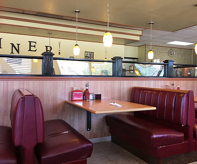Classic diner booths in that signature red &ndash; where family stories are shared and coffee refills appear like magic between sentences.