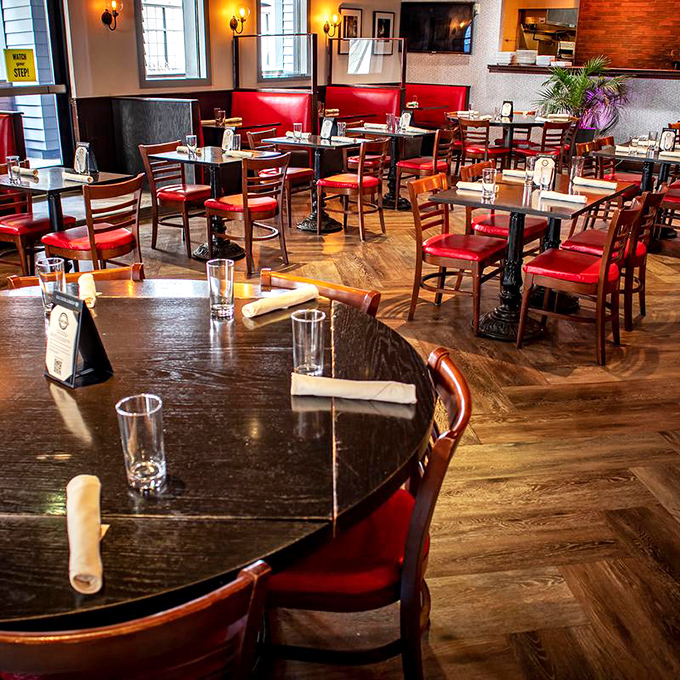 The herringbone wood floor leads your eye to the warm glow of the kitchen, like a delicious yellow brick road.