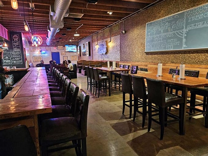 High-top tables and exposed brick walls create the perfect canvas for barbecue communion. Notice nobody's looking at their phones &ndash; the food commands full attention.